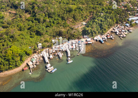 Balabac port. Houses on the water and various boats in the bay, view ...