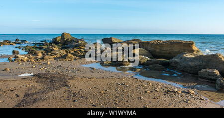 Big stones on the edge of the Black Sea. Autumn day by the sea near the ...
