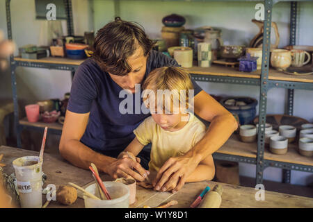 Father and son doing ceramic pot in pottery workshop Stock Photo - Alamy
