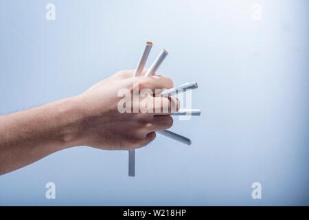 Hand smashed some cigarettes on gray background Stock Photo - Alamy