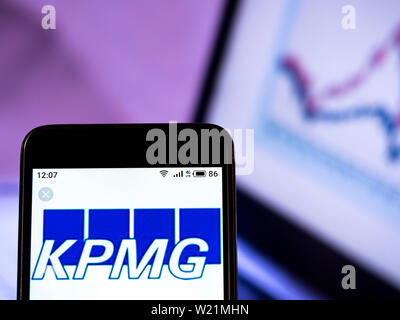 In this photo illustration, the KPMG logo is displayed on a smartphone ...