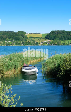Mattsee: lake Mattsee, ship canal to lake Obertrumer See, motorboat in ...