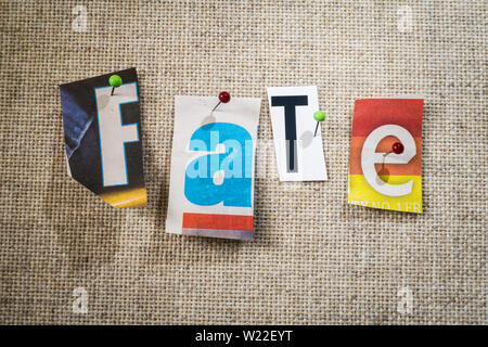 The word fate on a bulletin board with ransom note effect typography ...