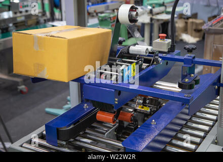 Semi automatic cardboard box tape sealing machine Stock Photo - Alamy