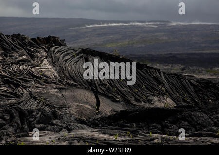 Pahoehoe lava flow and Mauna Loa a shield type volcano from Saddle Road ...