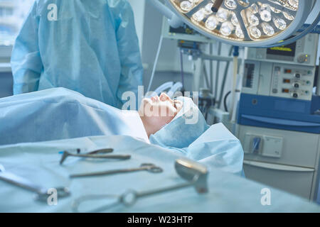 Several doctors surrounding patient on operation table during their ...