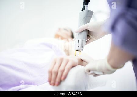 Woman getting laser treatment in medical spa center, permanent hair ...