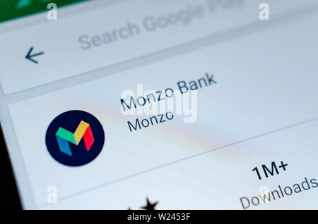 Monzo Bank app on the smartphone screen next to the Monzo debit card ...