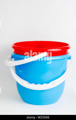 Plastic buckets on color background Stock Photo - Alamy