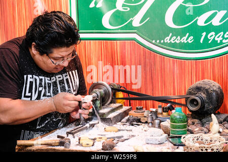 An Ecuadorian artist carves tagua nut Stock Photo - Alamy