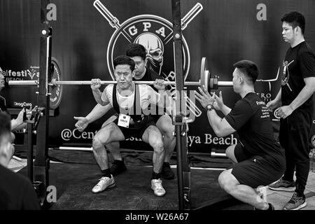 Power lifting male competitor participating in a weightlifting ...