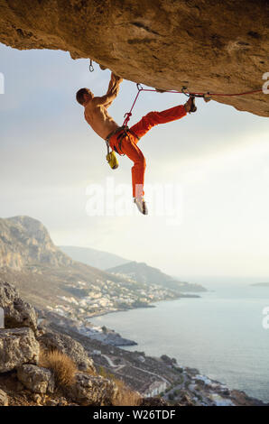 Beautiful view to rock climber climbing on steep rocky wall Stock Photo ...