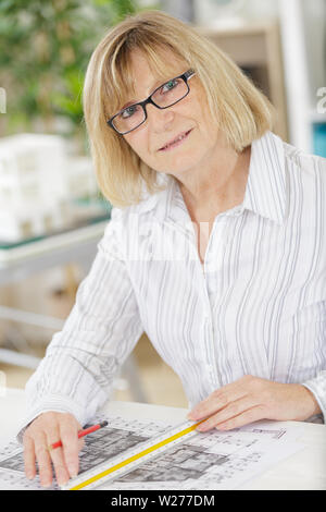 Female architect using scale ruler Stock Photo - Alamy