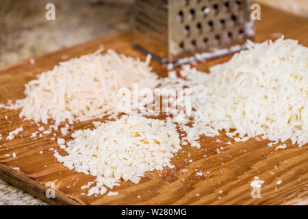 Using a variety (mozzarella, parmesan and romano) of grated cheeses on ...