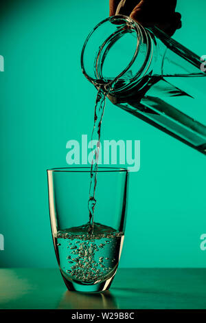 Man pours water from glass Stock Photo - Alamy