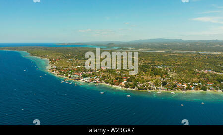 Shore with hotels near coral reef and diving boats, Moalboal ...
