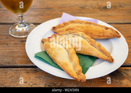 Traditional Lithuanian pastries Kibinai and glass of beer. Food popular ...
