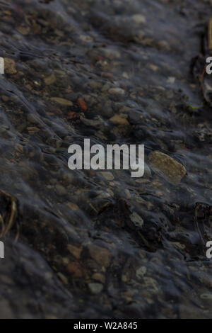 mud in the rain creating mini waterfall and river Stock Photo - Alamy