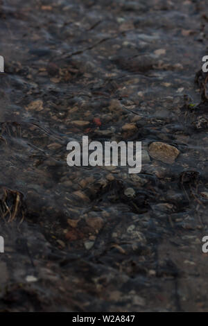 mud in the rain creating mini waterfall and river Stock Photo - Alamy
