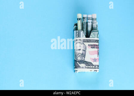 Package of cigarette filled with paper money dollars banknote and ...