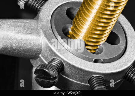 Steel threading die. Bronze bolt shaft in detail. Close-up of work with ...