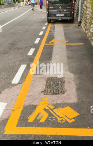 Yellow parking symbol for loading and unloading goods on the ground ...