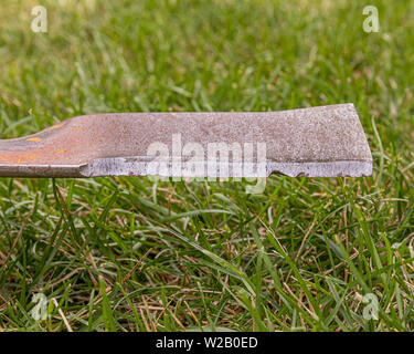 Lawn mower blade that is rusty, damaged, and dull and needing sharpened ...