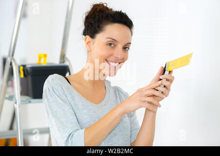 attractive woman tinkering in home workshop Stock Photo - Alamy