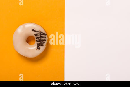 Doughnut with split color yellow and white background, close up food ...