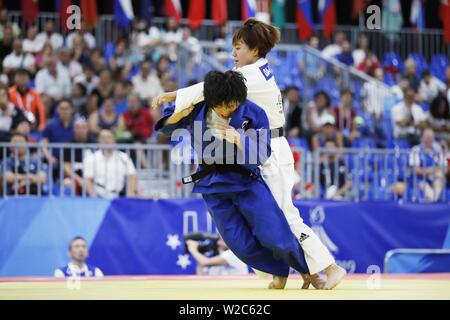 Ryoko Takeda of Japan, blue, fights against Park Da-sol of South Korea ...
