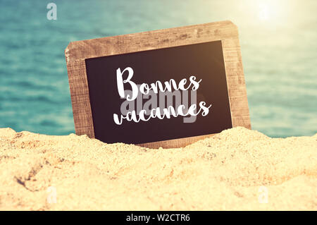 Bonnes vacances (meaning happy summer) written on a paper on colorful ...