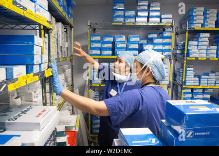 Nurses check supplies in a storeroom in an NHS Hospital Stock Photo - Alamy