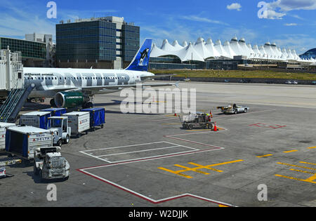 Frontier Airlines with aircraft at gate, while characterized as a low ...