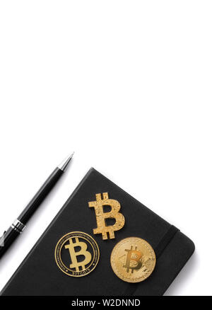Close Up three bitcoin coins, notepad and pen isolated on white.Top ...