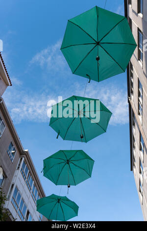 Colorful decorative umbrellas hanging from cables Stock Photo - Alamy