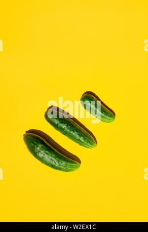 Concept Cucumbers Family on a yellow background. Dad mom baby ...