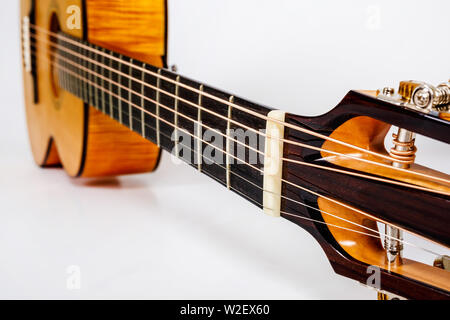 Tuning pegs on wooden machine head of six strings guitar on white ...