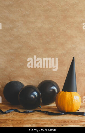 A big black pumpkin decorated with black ribbon on the table. Fall ...