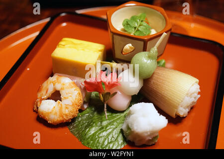 Hassun feature dish with tiger prawn, kinome leaf, rice cake, bamboo ...