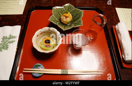 Hassun feature dish with tiger prawn, kinome leaf, rice cake, bamboo ...