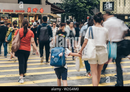 Causeway Bay, Hong Kong, 08 July 2019: Commuter in busy crosswalk ...
