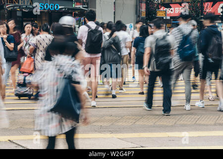 Causeway Bay, Hong Kong, 08 July 2019: Commuter in busy crosswalk ...