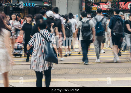 Causeway Bay, Hong Kong, 08 July 2019: Commuter in busy crosswalk ...