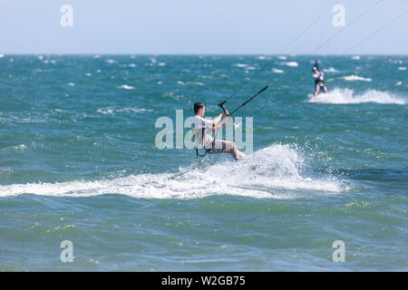 Tricks of professional kitesurfing athletes Stock Photo - Alamy
