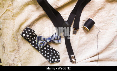 bow tie neck tie and braces for baby boy background Stock Photo - Alamy