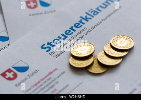 several golden coins on Swiss tax declaration form, Canton of Zurich ...