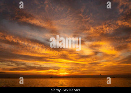 Beautiful sunset over the calm sea with cloud and sky background ...