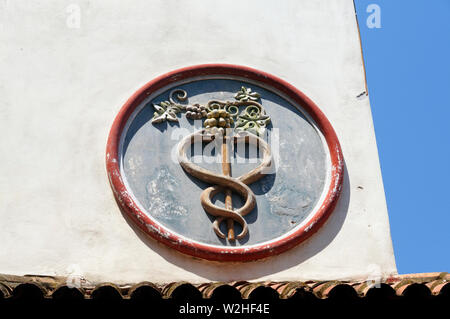 Symbol of the Greek God Aesculapius, on an Italian building in Kos Town ...