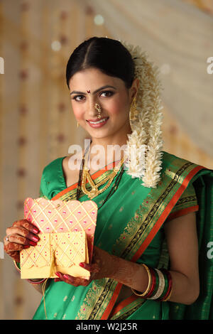 Woman opening a envelope and smiling Stock Photo - Alamy