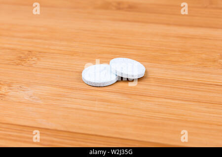Dental fizzy teeth cleaning tabs on a wooden background Stock Photo - Alamy